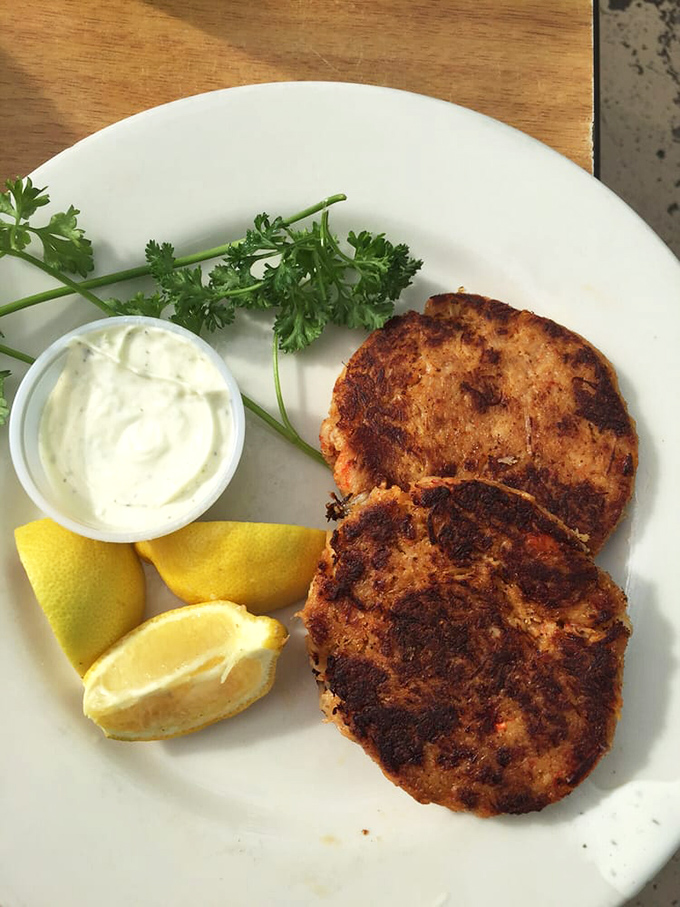 Crab cakes that are all crab, no cake. These golden-brown beauties with homemade tartar sauce prove that simplicity is the ultimate sophistication.