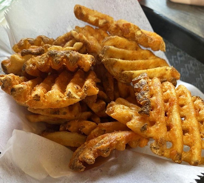 Waffle fries - the intellectuals of the fry world - with extra surface area for maximum crispiness and seasoning absorption. Pure potato engineering genius.