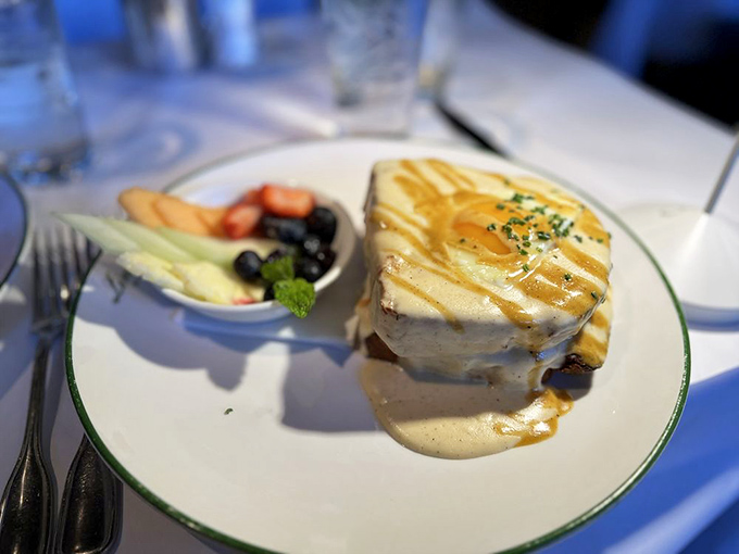 This isn't just breakfast, it's breakfast wearing evening attire—a croque madame dressed to impress with golden cheese and sauce.