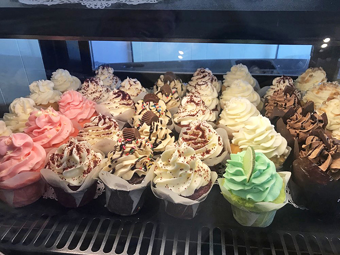 Cupcake heaven in technicolor glory. Each frosted masterpiece stands at attention, daring you to choose just one from this sweet battalion.