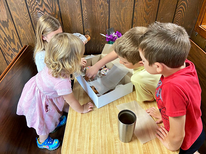 Creating childhood memories one donut box at a time. Those kids' faces say everything about anticipation.