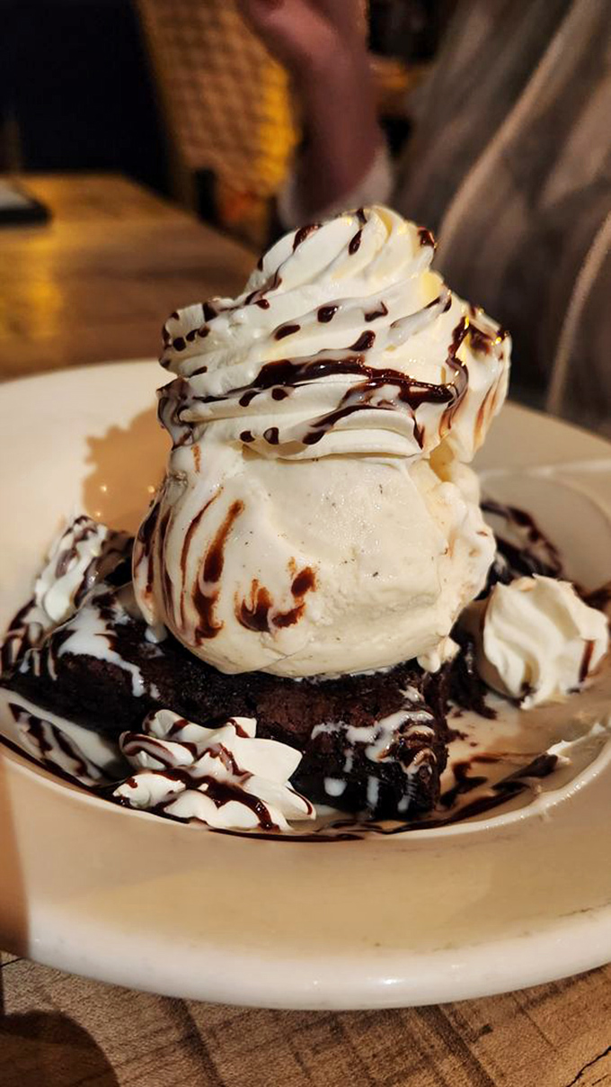 This isn't just dessert; it's a chocolate monument topped with a vanilla cloud &ndash; the kind of sweet finale that makes you reconsider ordering seconds.