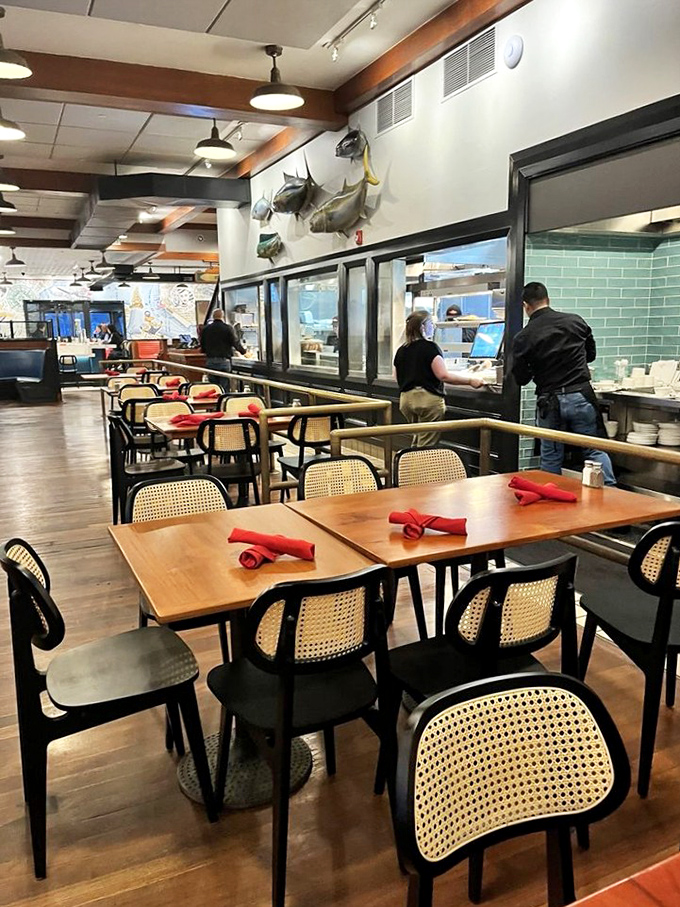 Cane-backed chairs and red napkins set the stage for the real star: whatever oceanic delight is about to grace your table.