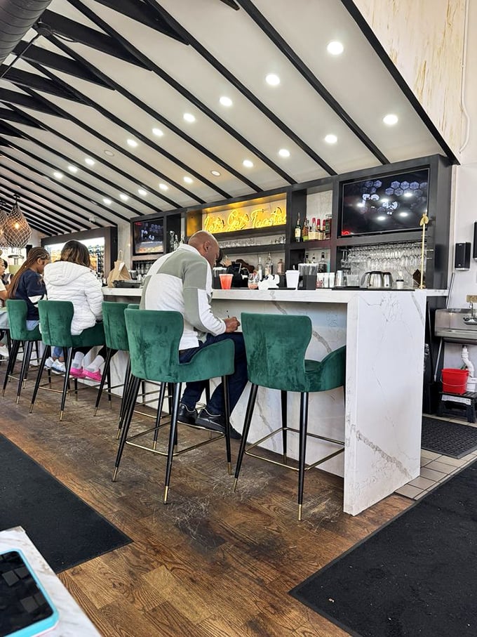 The marble bar creates a perfect perch for solo diners or couples, where emerald velvet stools invite you to settle in for a mimosa marathon.