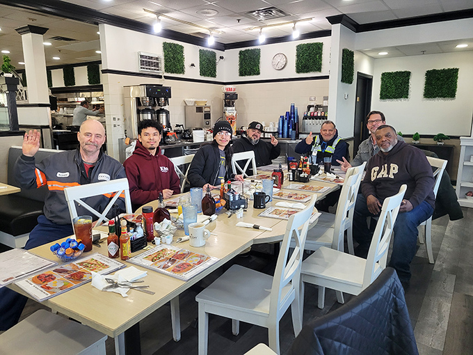 Happy diners gathered around a table of possibilities – the universal language of breakfast bringing people together.