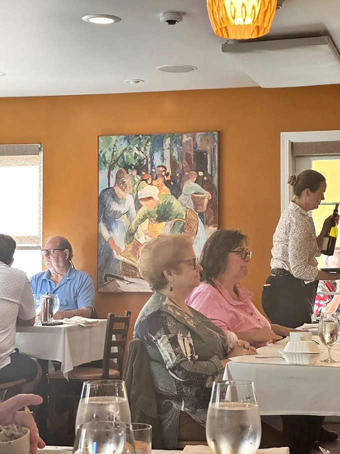Diners lost in culinary bliss while colorful artwork watches over them. This is the face of people experiencing food worth driving hours for.