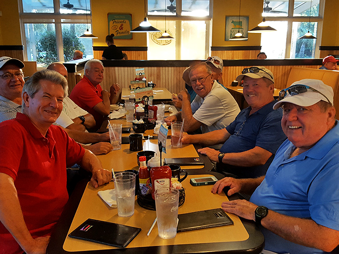 A table of regulars sharing stories over coffee and eggs&mdash;the true heart of any great breakfast spot. These gentlemen clearly know where to find the good stuff.