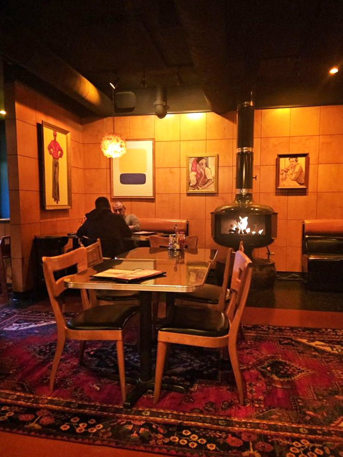 A wood-burning stove creates the ultimate hygge corner for Portland's rainy days. That oriental rug has witnessed countless first dates and life-changing dessert decisions.