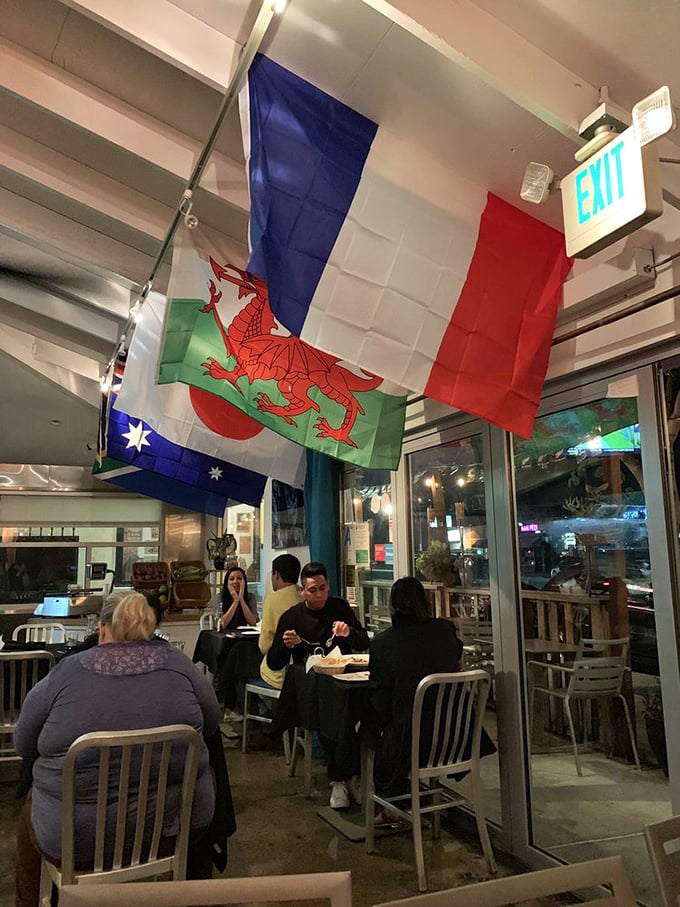 Under international flags that hint at global seafood inspirations, diners engage in the universal language of "mmm" and "you have to try this."