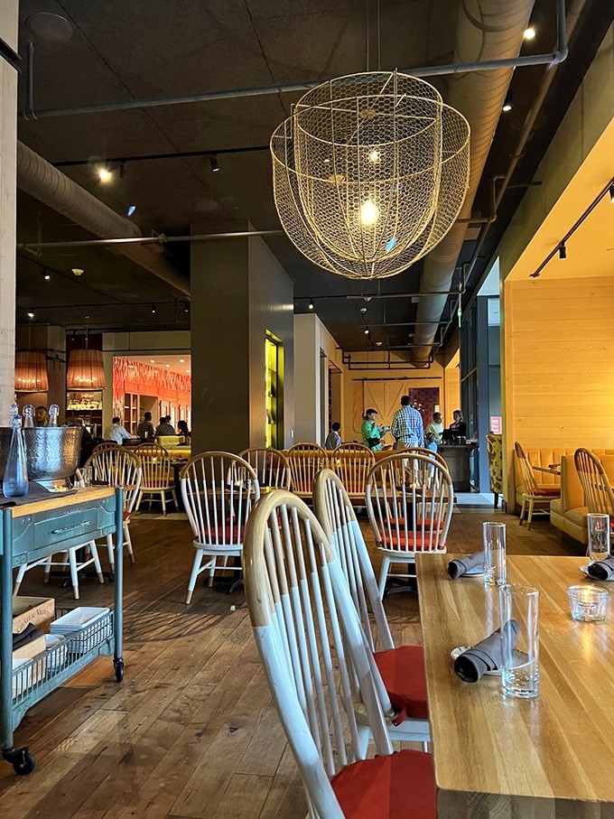 Wire basket chandeliers hover above Windsor chairs&mdash;rustic elegance that makes you feel simultaneously sophisticated and comfortably at home.