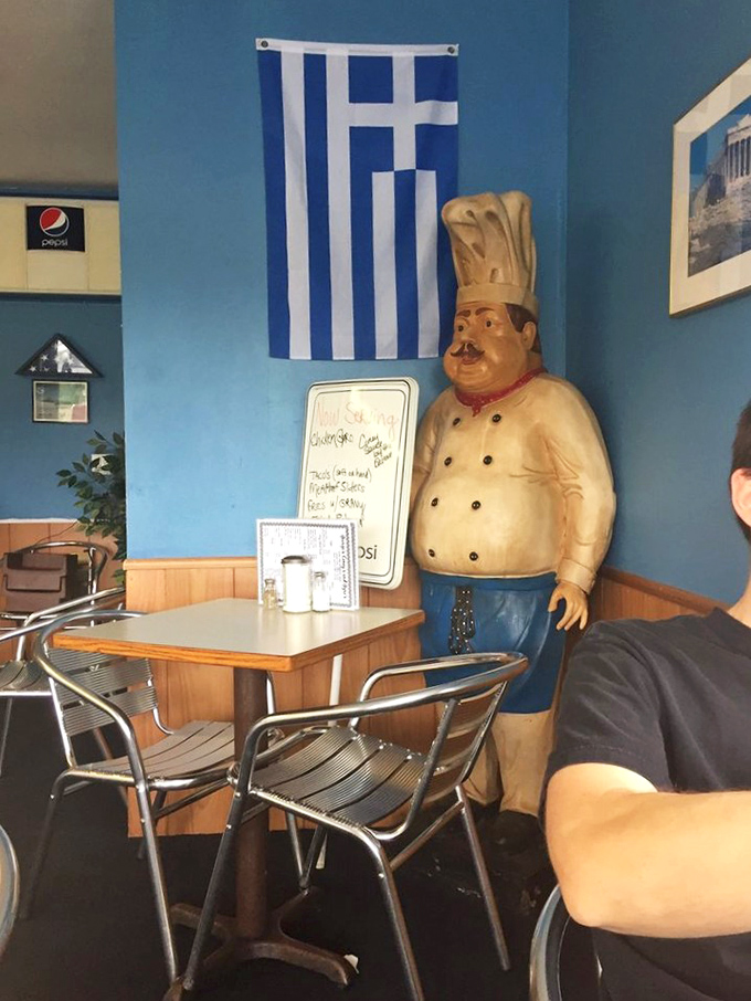 That chef statue silently watches over diners like a portly guardian angel, promising Mediterranean authenticity with his permanent smile.