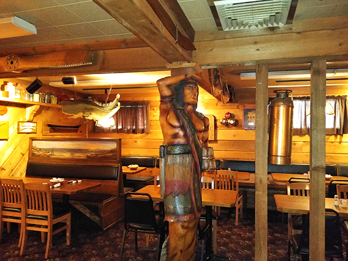 Carved wooden statues and rustic decor transport you to a north woods lodge. Indiana meets wilderness in this charming dining space.
