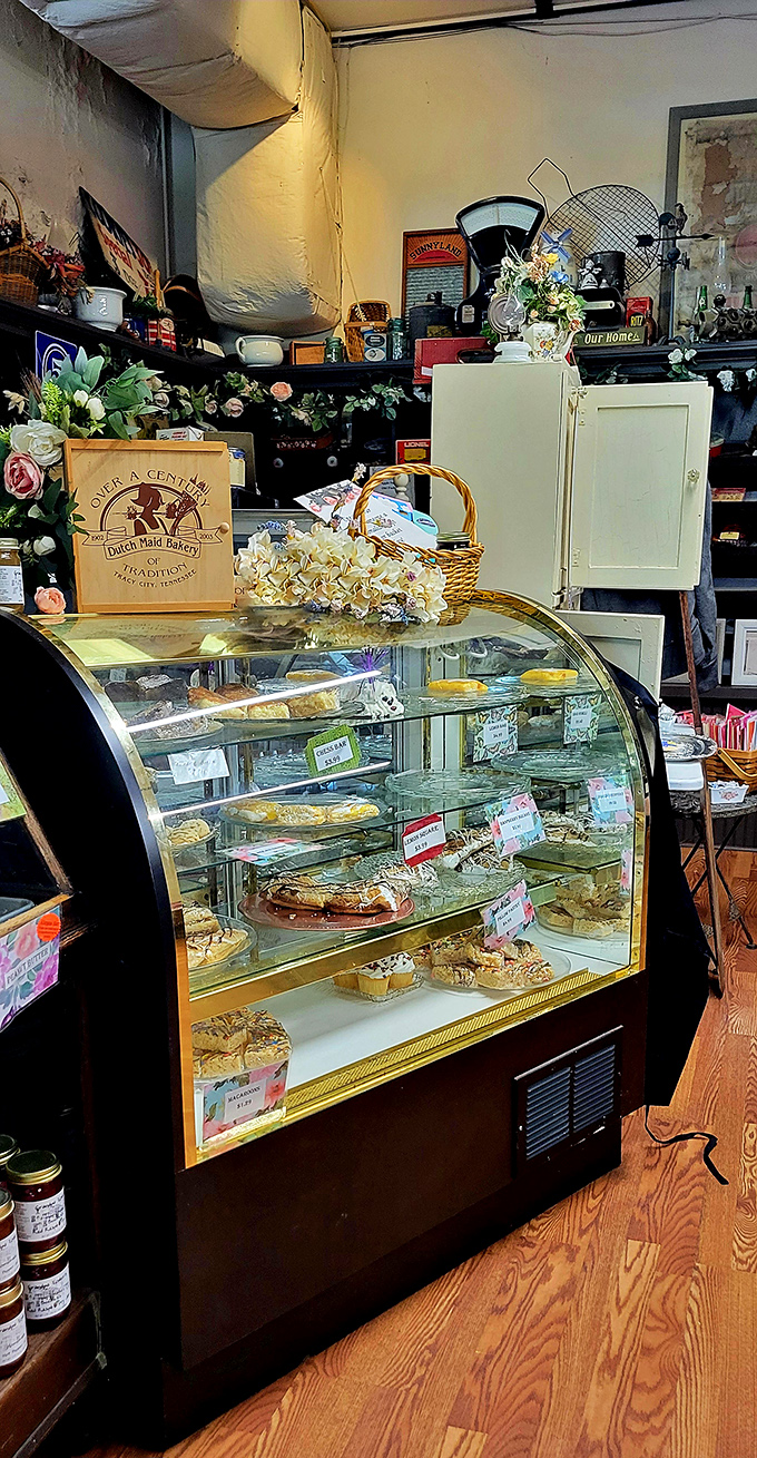 The display case&mdash;where diet plans go to die. Each shelf showcases baked treasures that make choosing just one an exercise in delicious futility.