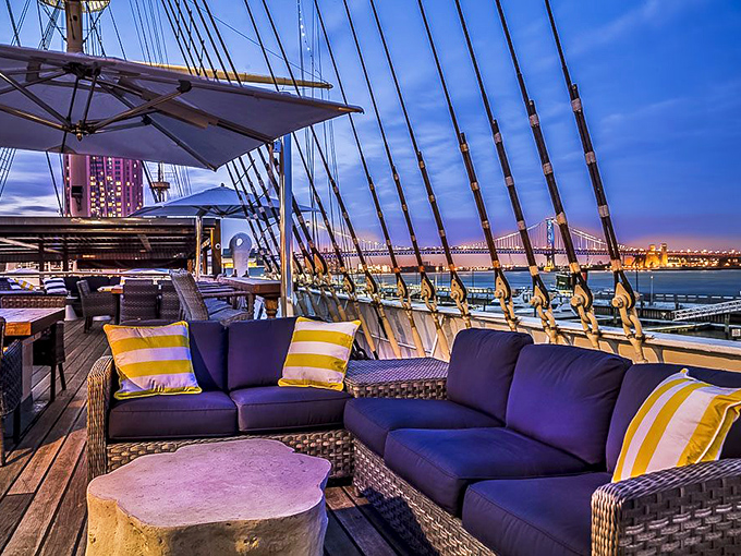 Twilight transforms the Moshulu's deck into a realm of impossible romance, where cocktails and cushions conspire to make you forget there's a world beyond these twinkling lights.