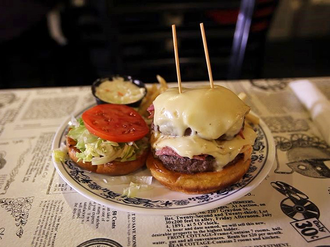 A burger that requires both engineering skills and an unhinged jaw to consume properly. Worth every napkin and potential shirt stain.