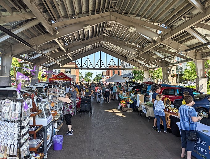 The farmers market buzzes with activity under protective covering &ndash; where local produce and handcrafted goods create a shopping experience that big box stores can't match.