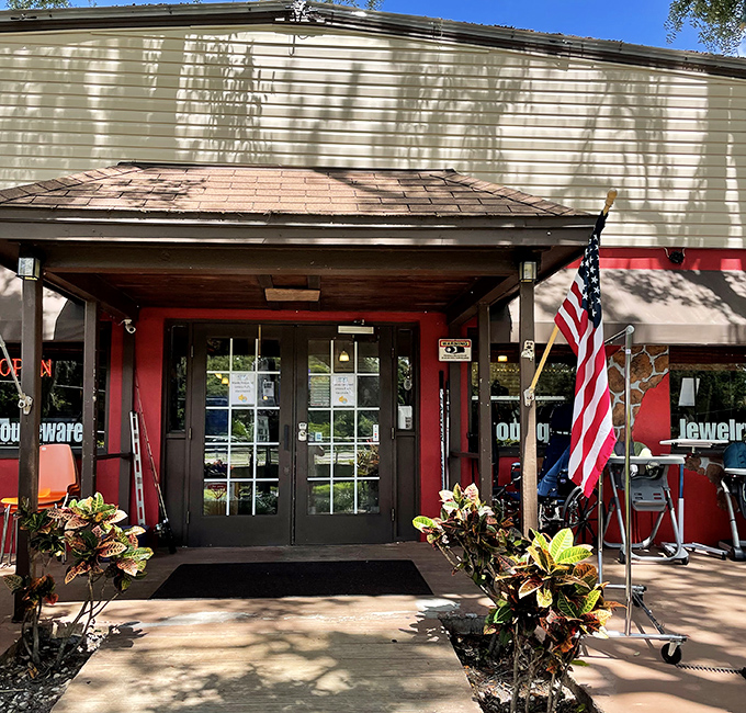 The entrance beckons with American flag pride and Florida foliage. Like the gateway to a parallel universe where everything costs less.