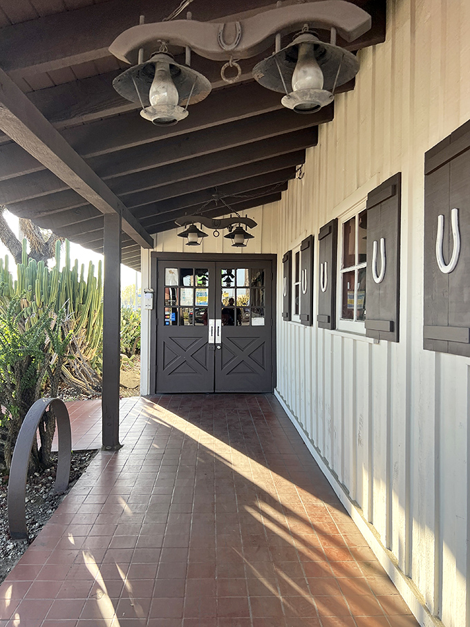 The entrance pathway, lined with horseshoe decorations, feels like walking into a family friend's ranch house rather than just another restaurant.