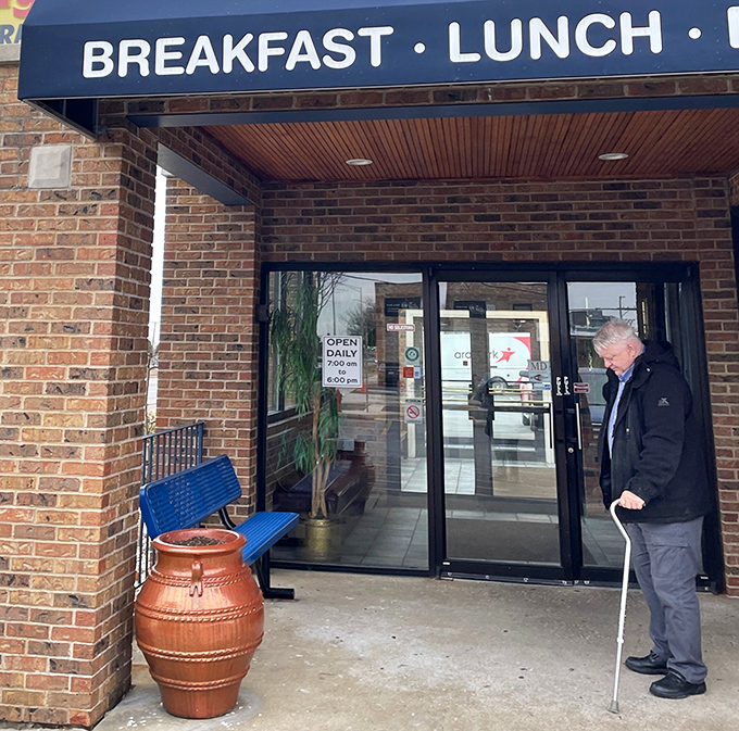 The entrance: where hunger goes to die and satisfaction begins its reign. That blue bench has heard some stories.