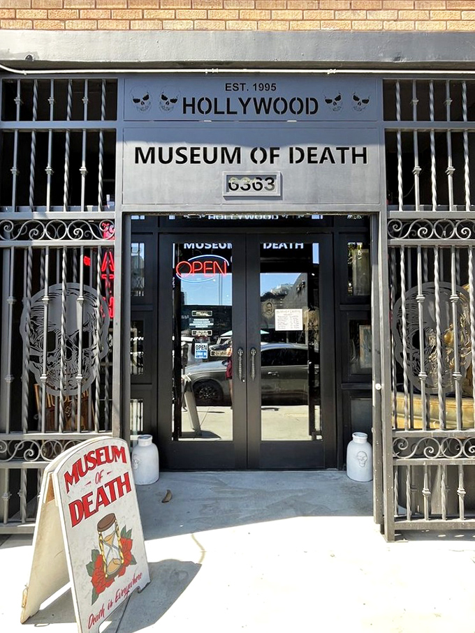 The museum's entrance features wrought iron gates and skull motifs – subtle foreshadowing of what awaits inside. The "Open" sign seems almost comically ordinary.