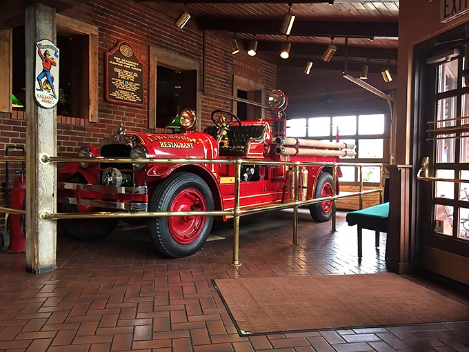 Not just decoration, this vintage fire truck stands as a gleaming red guardian of tradition in this temple of Tennessee barbecue.