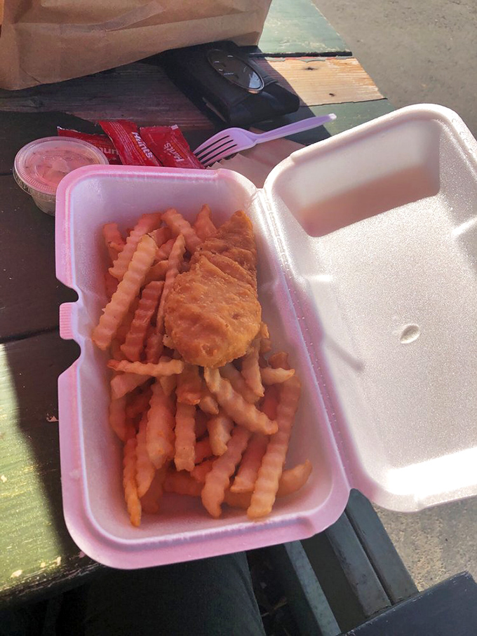 Crispy fish and golden fries in an unpretentious foam container&mdash;proof that sometimes the simplest presentations deliver the most satisfying flavors.