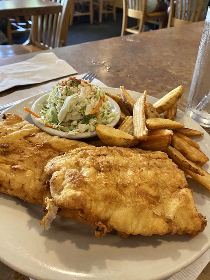 Fish and chips done right—golden, flaky fish with a crisp exterior that shatters just so, making you forget about calorie counting for one blissful meal.