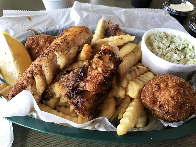 Fish so fresh it practically introduces itself, nestled among golden fries and a hush puppy that deserves its own fan club. Cole slaw provides the perfect cool counterpoint. 