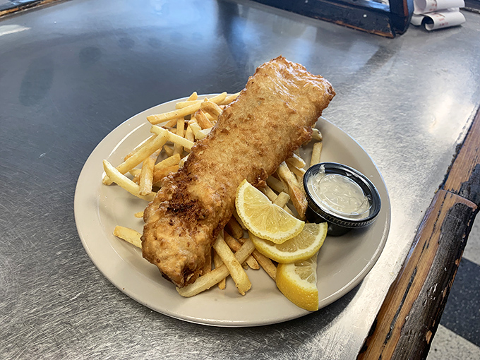 Fish and chips that would make a British pub proud&mdash;golden batter shattering at first bite, with fries standing by for sauce duty.