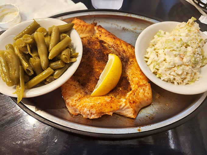 Perfectly grilled fish flanked by green beans and slaw—the holy trinity of Southern seafood dining that makes fancy big-city restaurants seem unnecessarily complicated.