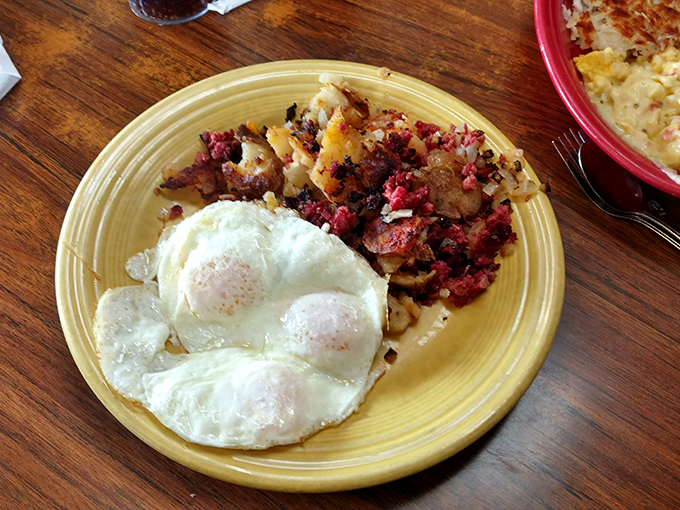 Two perfectly cooked eggs beside what appears to be a glorious hash—the kind of breakfast that fuels desert adventures or cures what ailed you yesterday.