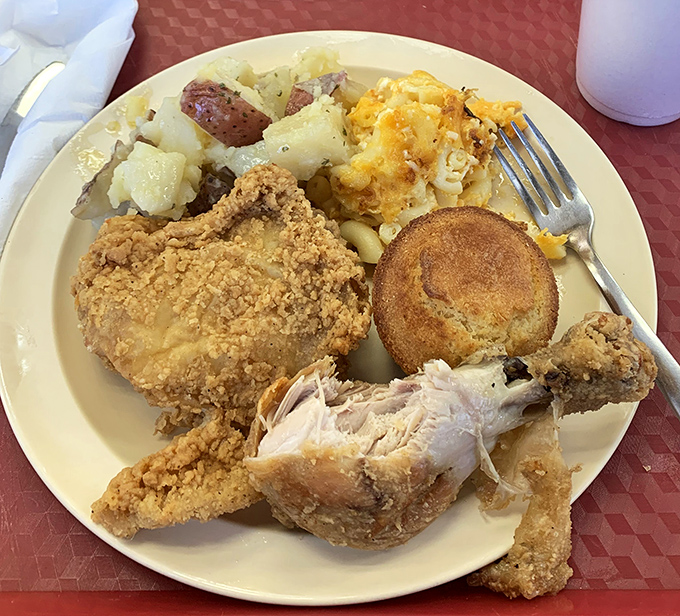 Fried chicken with that golden armor of perfectly seasoned crust alongside mac and cheese that refuses to be upstaged. A true power couple.