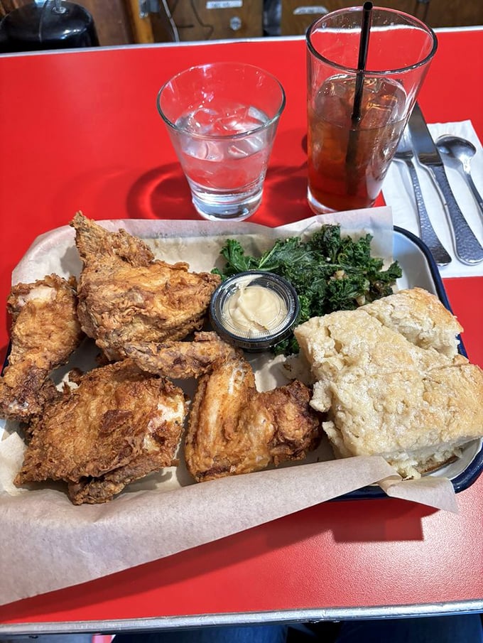 Fried chicken that achieves that mythical balance—shatteringly crisp outside, juicy inside—served with greens to ease your conscience.
