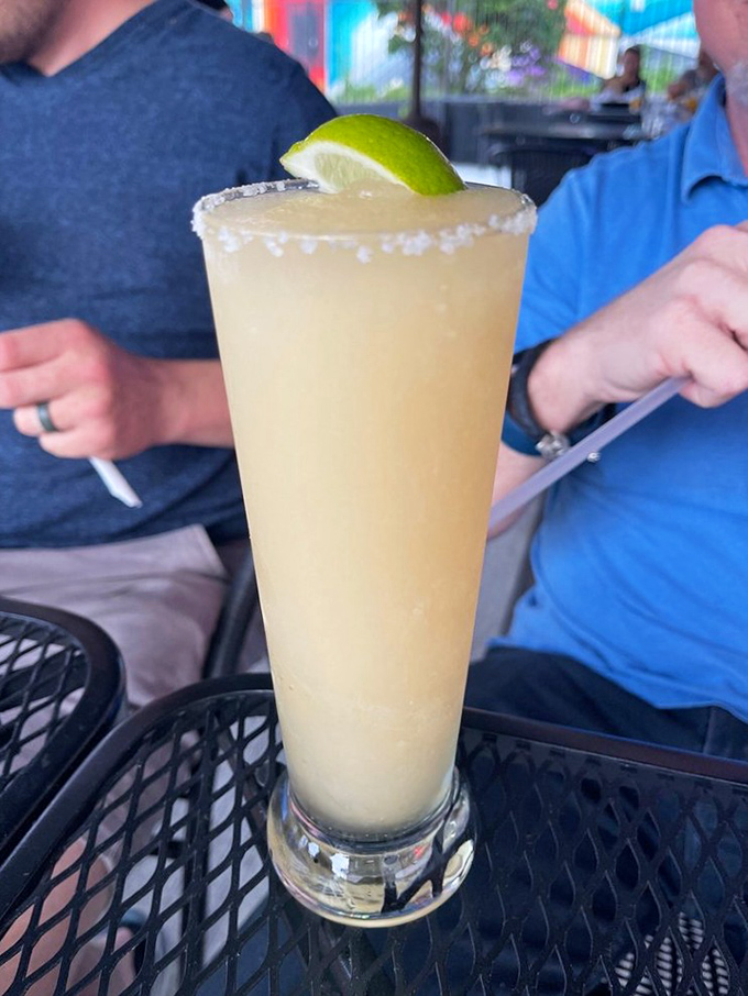 A salt-rimmed frozen margarita that looks like sunshine in a glass—the perfect companion while watching the world go by from the patio.