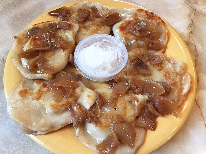 Caramelized onions cascade over perfectly pan-fried pierogies like edible gold in this aluminum treasure chest.