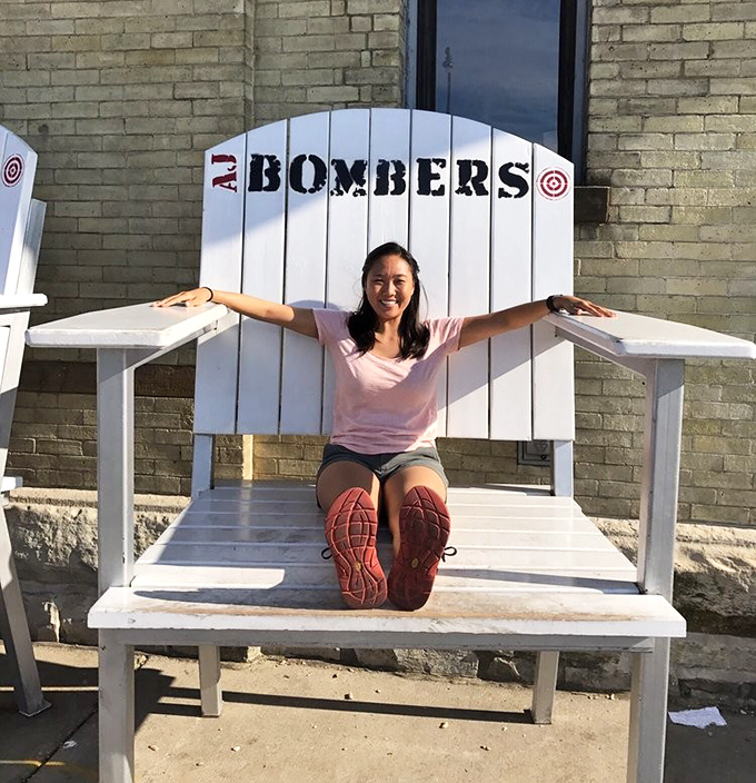 The oversized Adirondack chair outside isn't just photo-op furniture&mdash;it's a metaphor for how AJ Bombers makes everything feel larger than life.