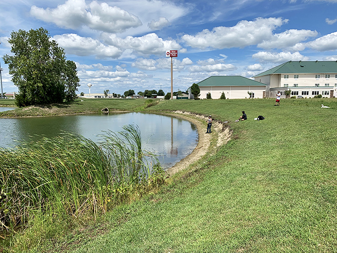 This serene pond at Green Mill Village Hotel offers a moment of reflection for travelers, where fishing enthusiasts can cast a line just steps from their accommodations.