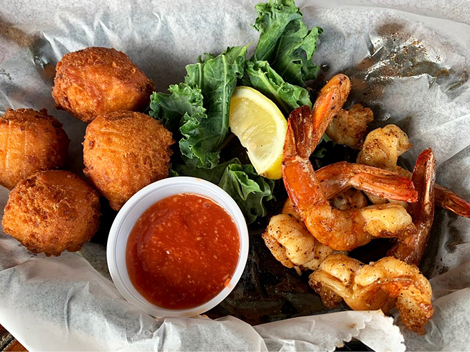 Seafood and hush puppies sharing a basket like old friends at a reunion&mdash;crispy, golden, and impossible to eat just one.
