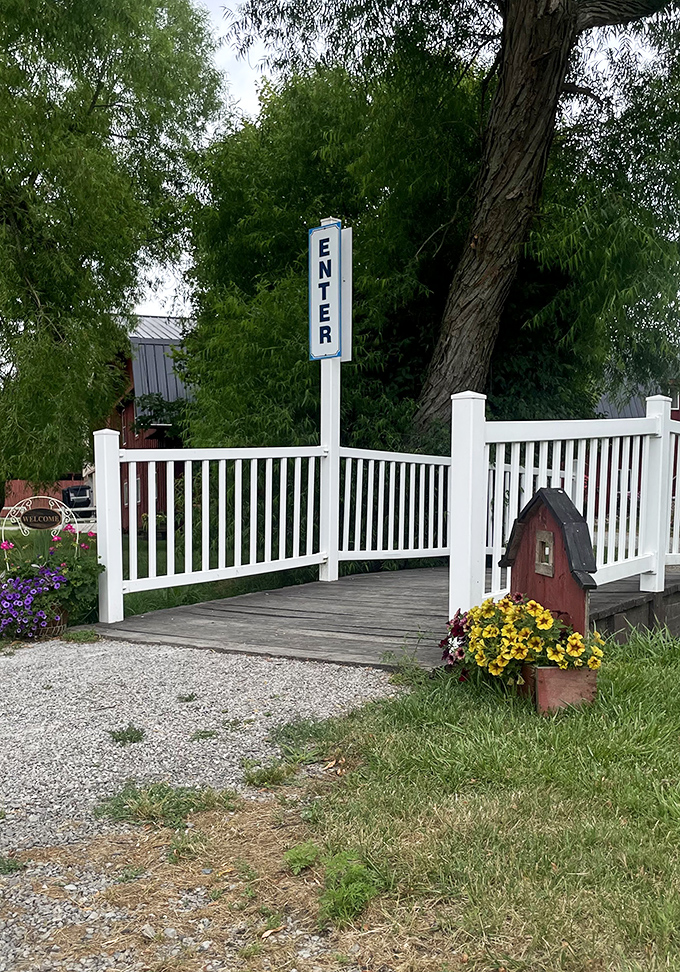 The entrance bridge welcomes visitors with cheerful flowers and a charming birdhouse&mdash;the Amish version of a five-star hotel lobby.