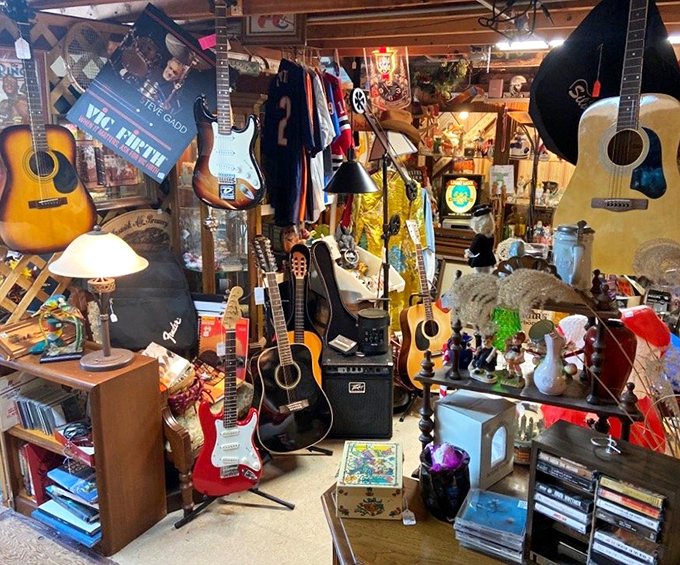 A musician's dream corner where vintage guitars hang like trophies, each one with strings that have likely strummed countless forgotten melodies.