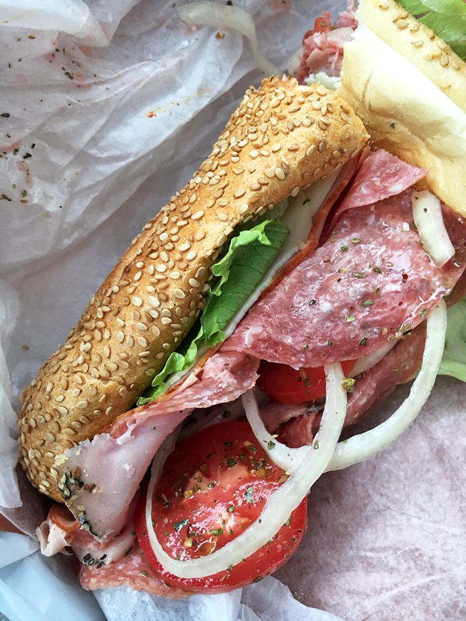Italian cold cuts layered with precision on a sesame-studded roll &ndash; this isn't just lunch, it's a Mediterranean vacation between two pieces of bread.