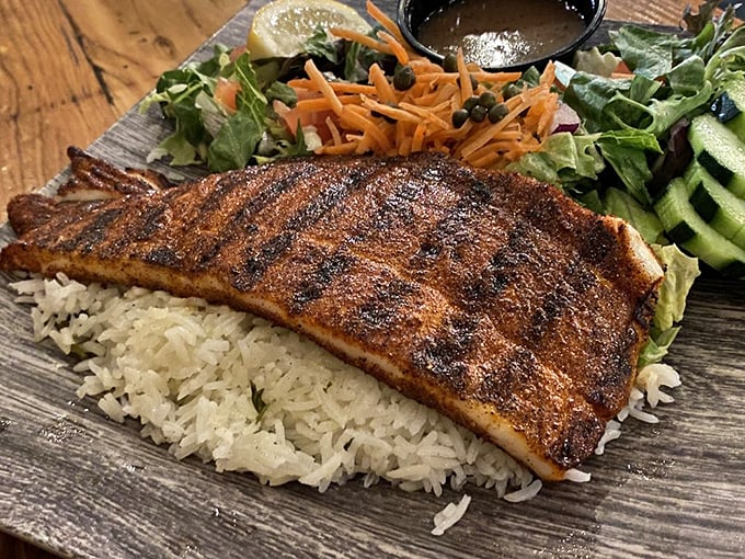 Blackened perfection atop a bed of rice. This beautifully seasoned fish proves that sometimes the simplest preparations yield the most spectacular results.