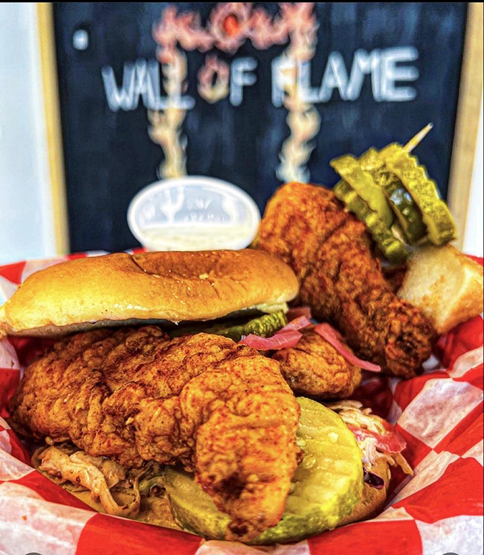 The "Wall of Flame" isn't just decoration – it's a warning and a promise of what awaits in this glorious hot chicken sandwich.