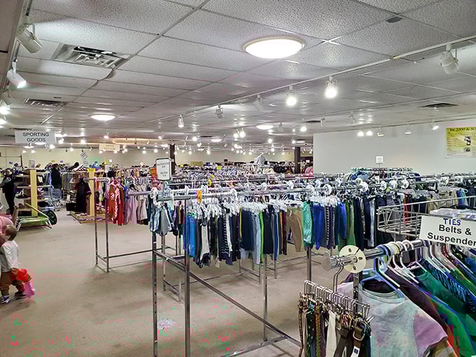 The clothing department stretches into the distance, a textile sea navigated by savvy shoppers. Signs helpfully direct you to specialized sections like ties and belts.