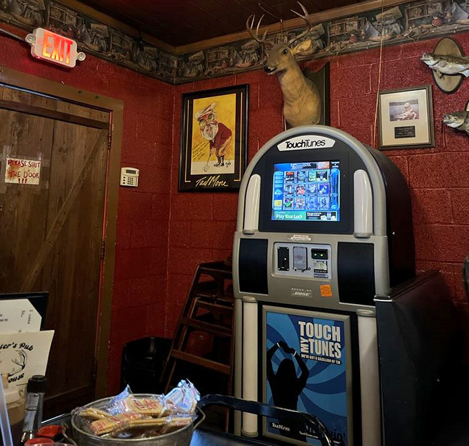 Every great steakhouse needs a soundtrack. The vintage jukebox stands ready beside mounted trophies, blending music with mealtime in true Southern style.