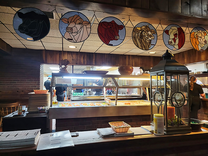 Stained glass cattle watch over the kitchen pass&mdash;a steak house that literally puts its mission statement on the ceiling.