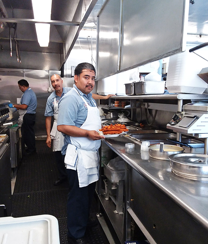 The wizards behind the curtain. Skilled kitchen staff transform fresh catches into culinary magic with practiced hands and secret techniques.
