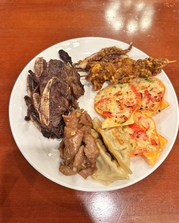 A plate showcasing the global nature of this buffet &ndash; Korean short ribs, dumplings, and seafood creating an international summit of flavors.