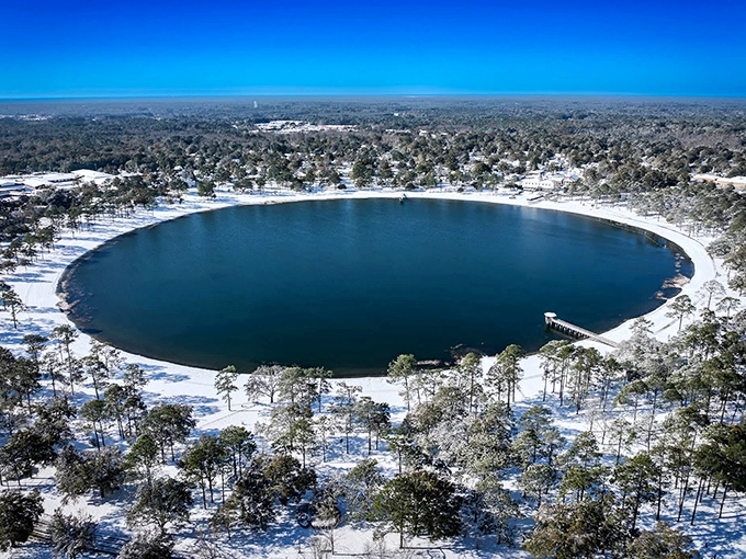 Lake DeFuniak in winter reveals a rare Florida sight—a perfect circle of deep blue surrounded by a dusting of snow. Mother Nature showing off again.
