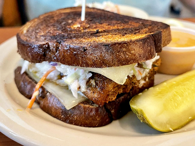 This sandwich isn't just lunch; it's architecture&mdash;a perfectly constructed tower of fish, cheese, and slaw that demands both hands and your full attention.